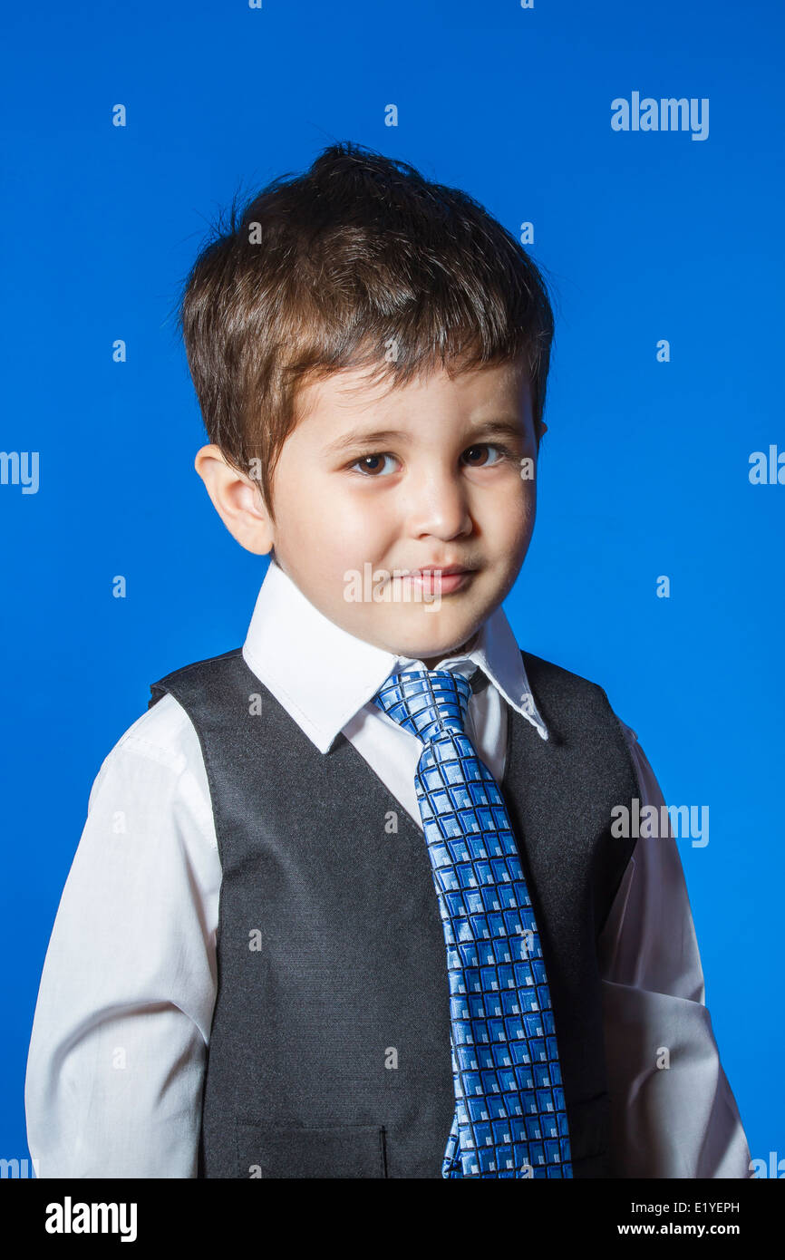 Leader, cute little boy portrait over blue chroma background Stock ...