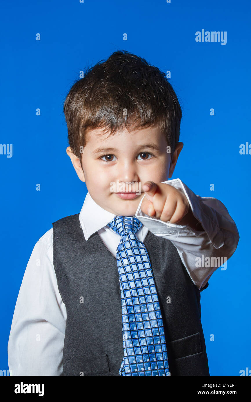Leader, cute little boy portrait over blue chroma background Stock ...