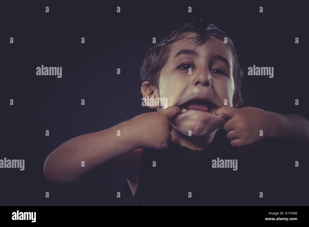 derision, boy dressed rocker with funny faces Stock Photo - Alamy