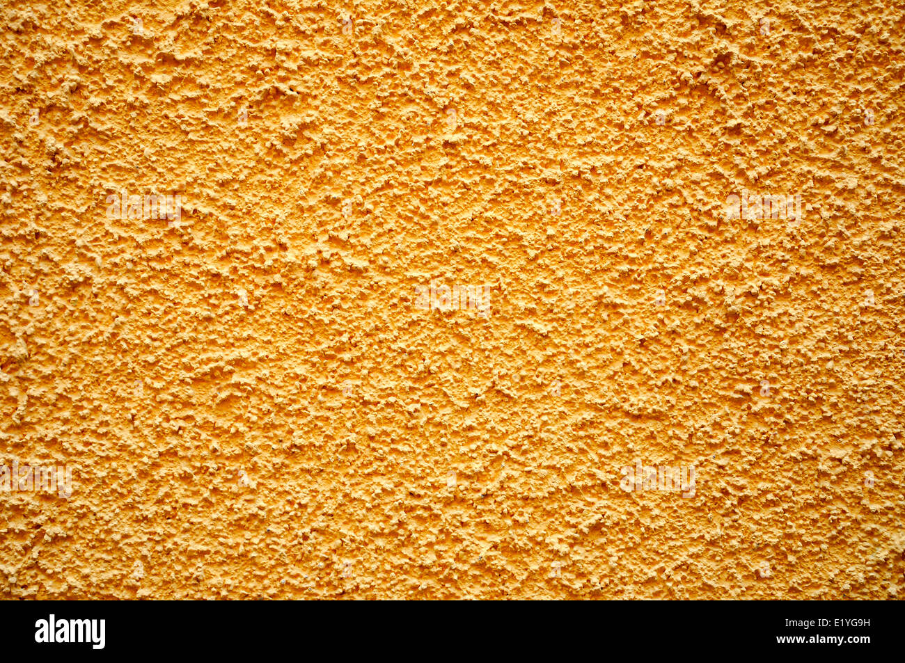 Background of yellow rough plaster Stock Photo - Alamy