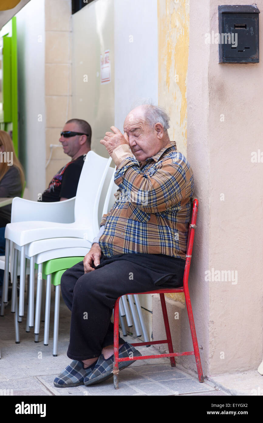 Older man sat near the waterfront in Marsaxlokk Malta Stock Photo - Alamy