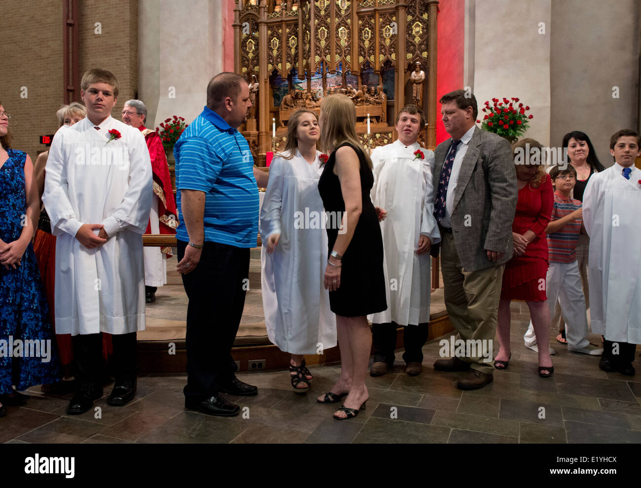 Parents congratulate their teenagers after the Rite of Confirmation service at St. Martin's ...