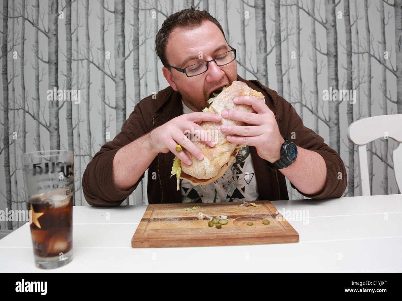 Man stuffing face hi-res stock photography and images - Alamy