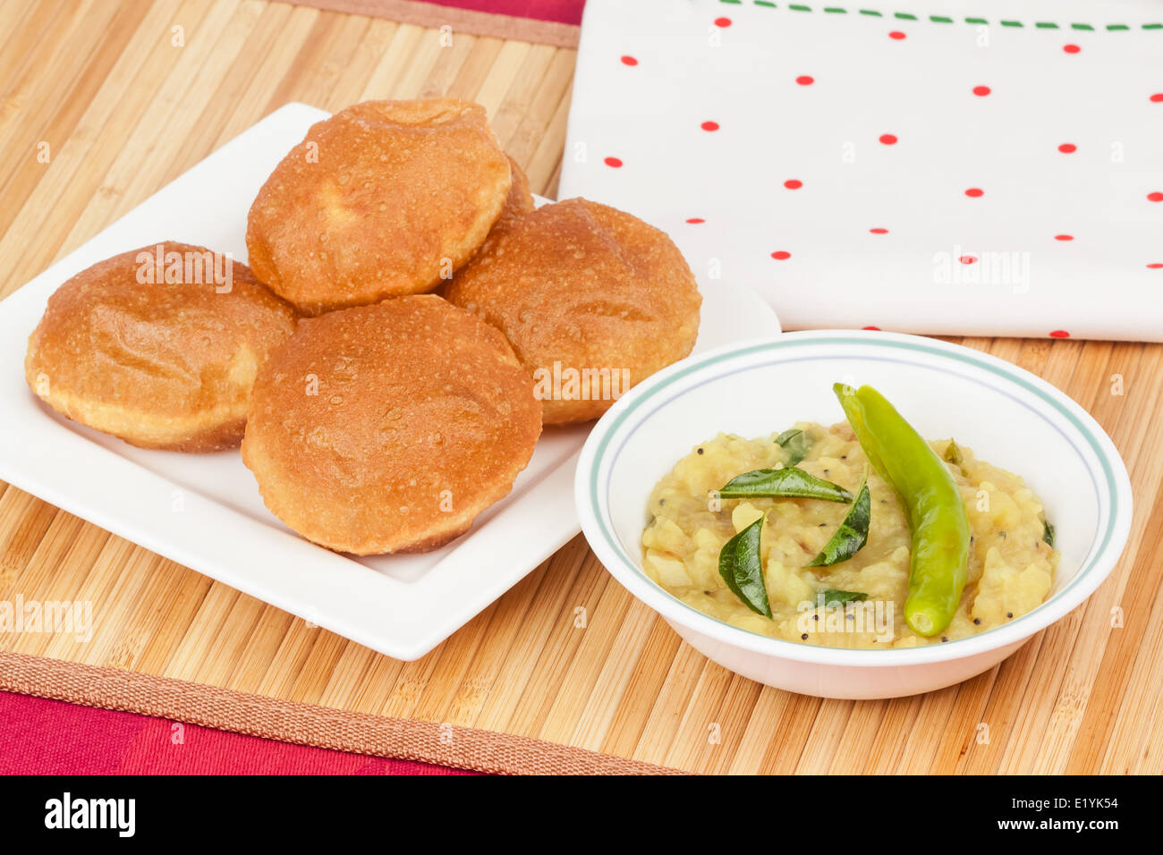 Delicious deep fried poori (puri) served with spicy potato onion curry ...