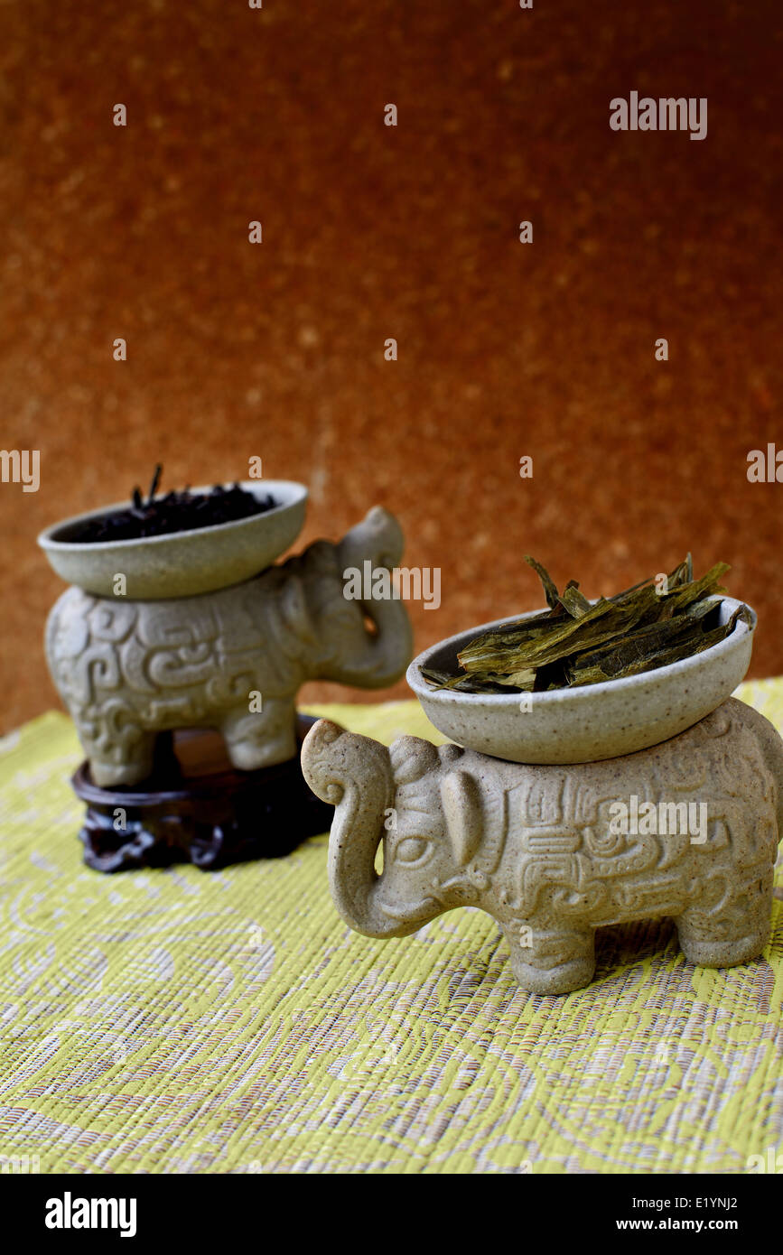 Two elephants carrying different tea types: green and black Stock Photo ...