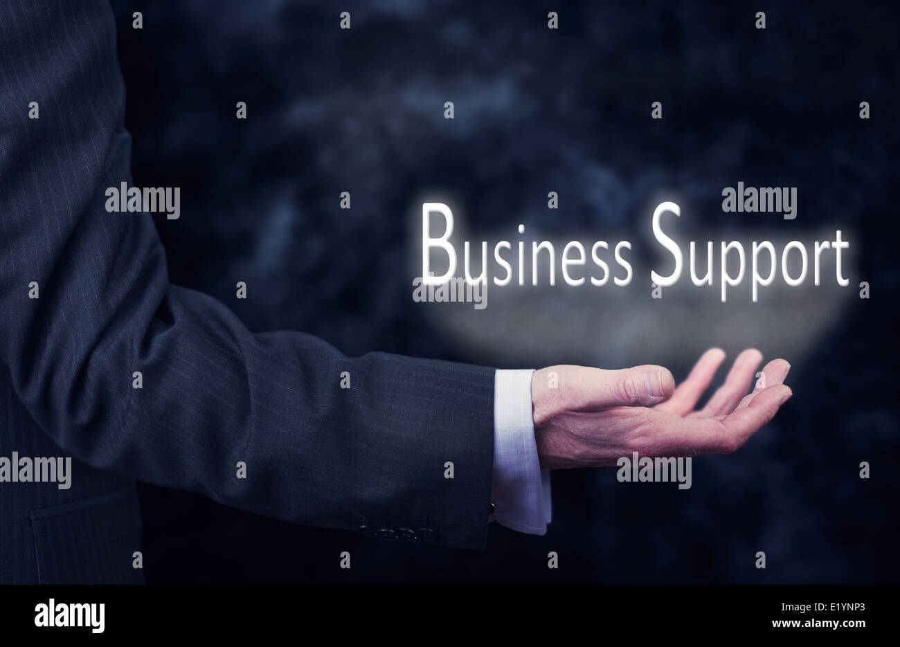 A businessmans hand holding the words, "Business Support Stock Photo ...