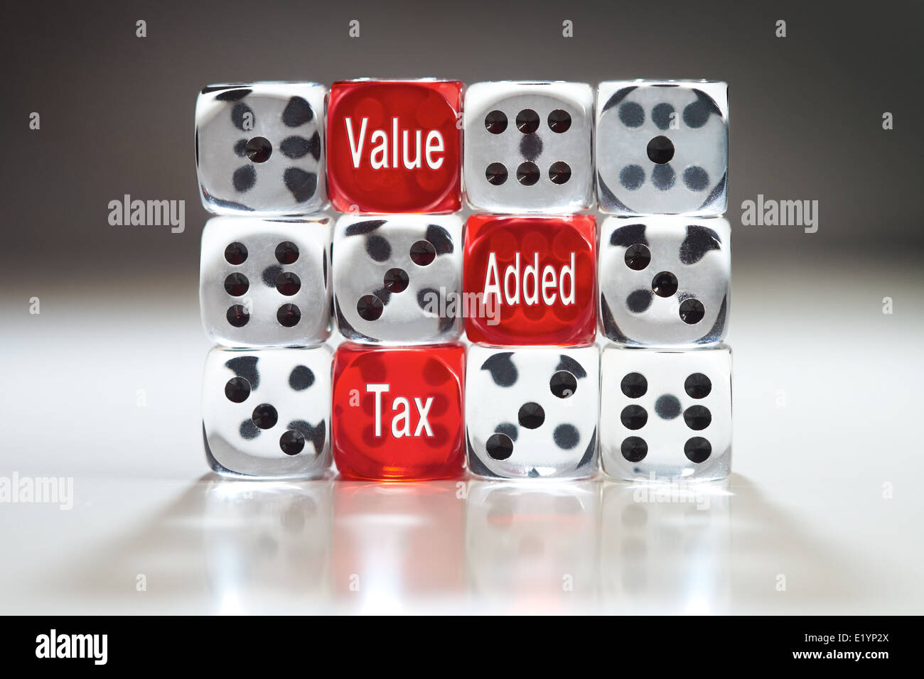 VAT concept, three red dice with Value, Added and Tax in a wall of ...