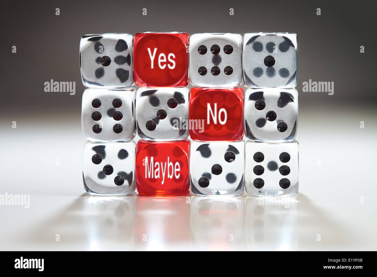 Chance concept, three red dice with Yes, No and Maybe in a wall of ...