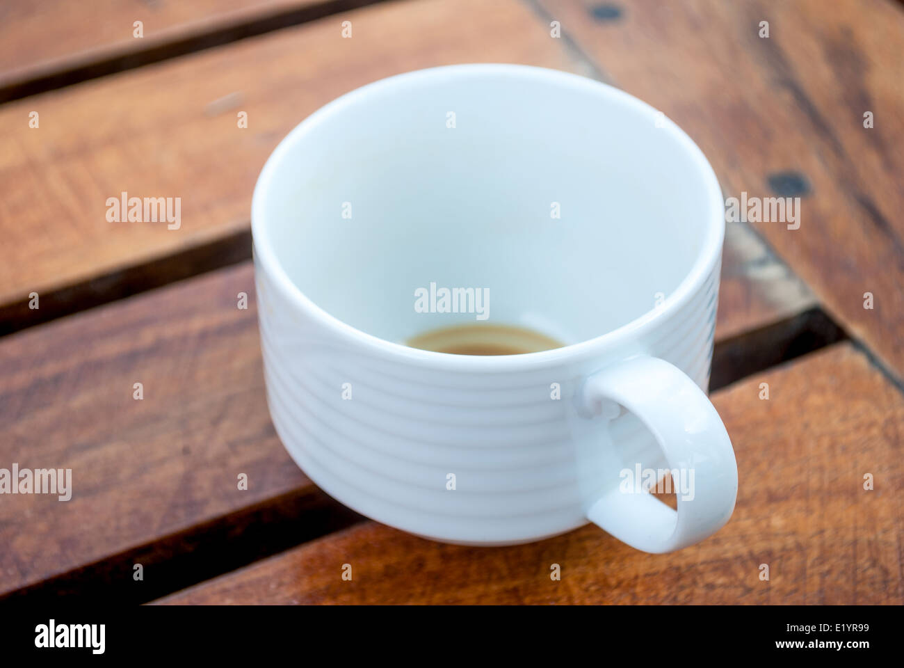 a single cup of coffee over a wood table Stock Photo - Alamy