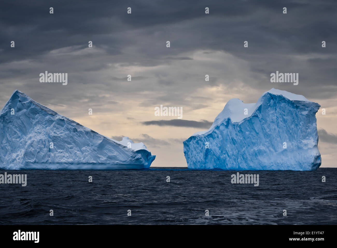 Huge icebergs in Antarctica, dark sky Stock Photo - Alamy