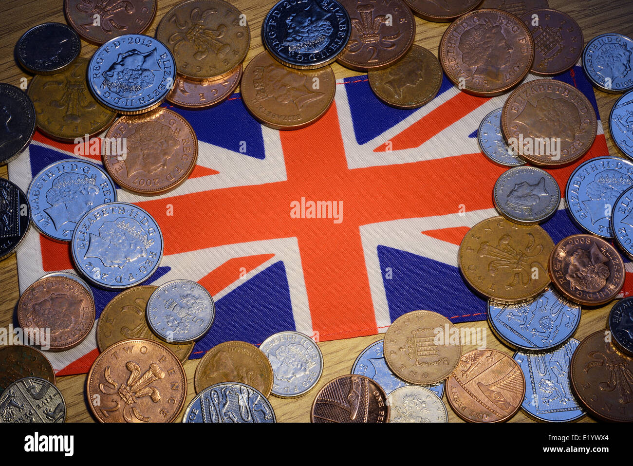 Coins and a Union Jack flag Stock Photo - Alamy