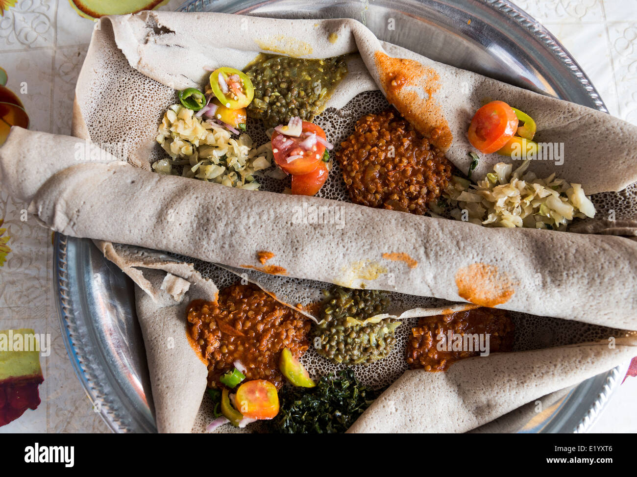 A traditional Injera dish with variety of veggies and sauces Stock ...