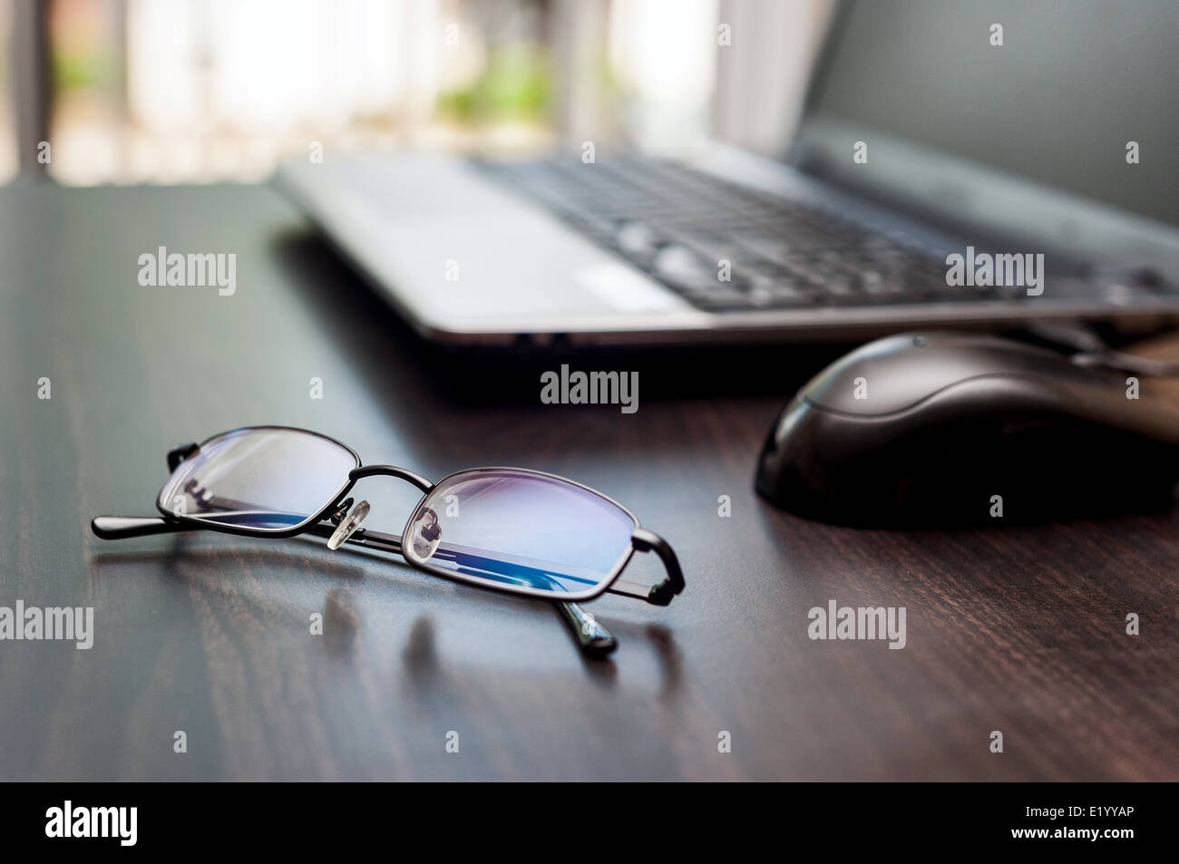 Eyeglasses on the desk Stock Photo - Alamy