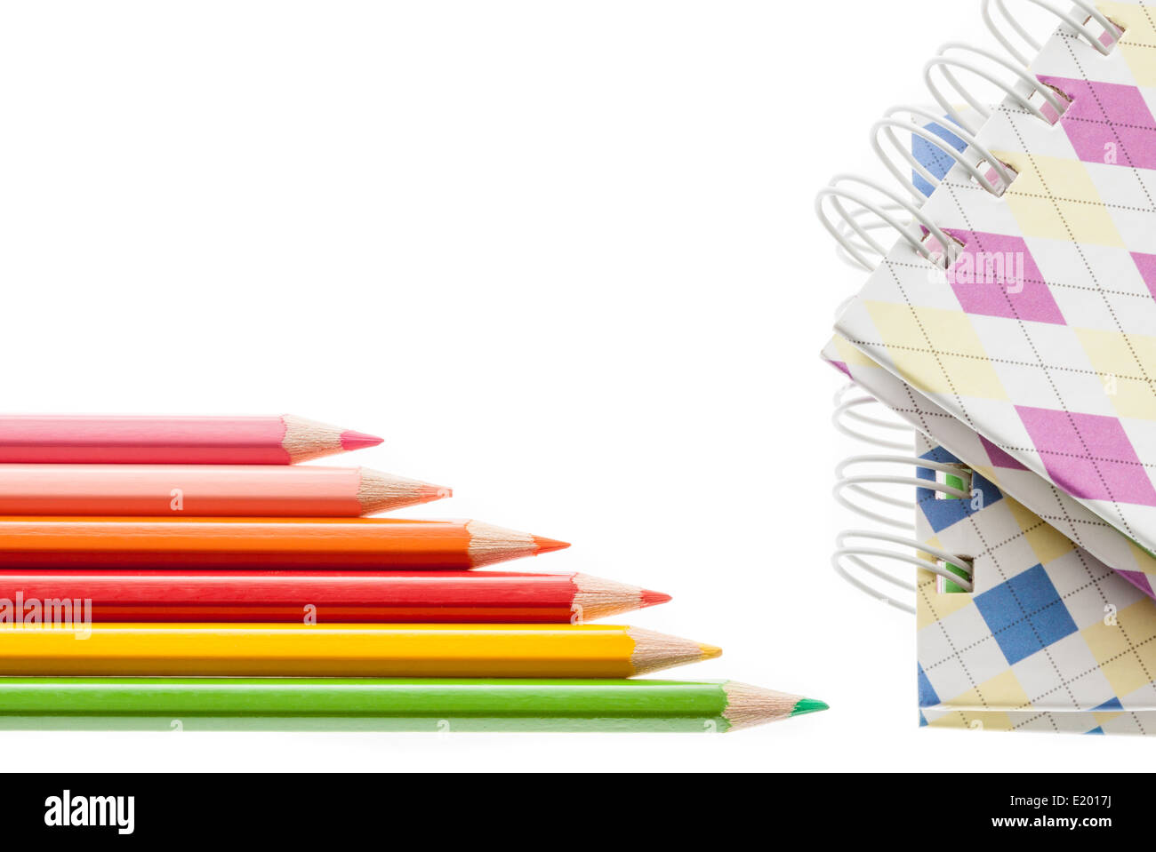 Closeup color pencil and notebook on white background Stock Photo - Alamy