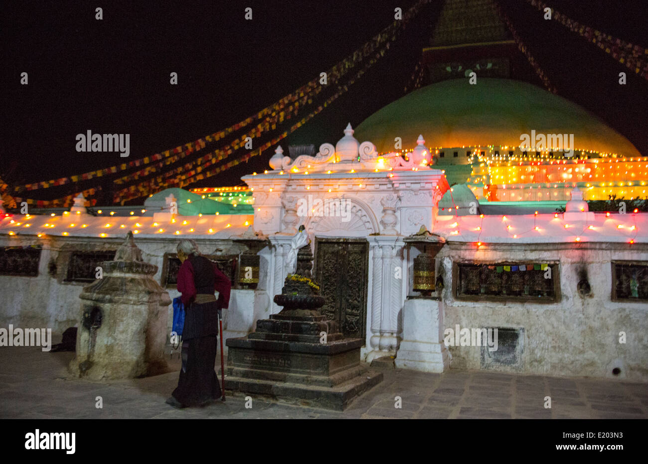 Kathmandu Nepal old woman walking around the Boudhanath Stupa in the ...