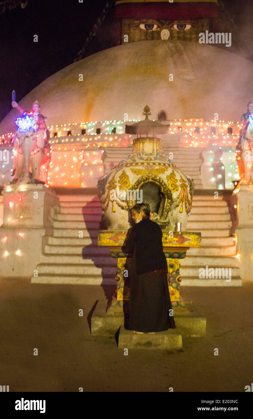 Kathmandu Nepal old woman praying at the Boudhanath Stupa in the early ...