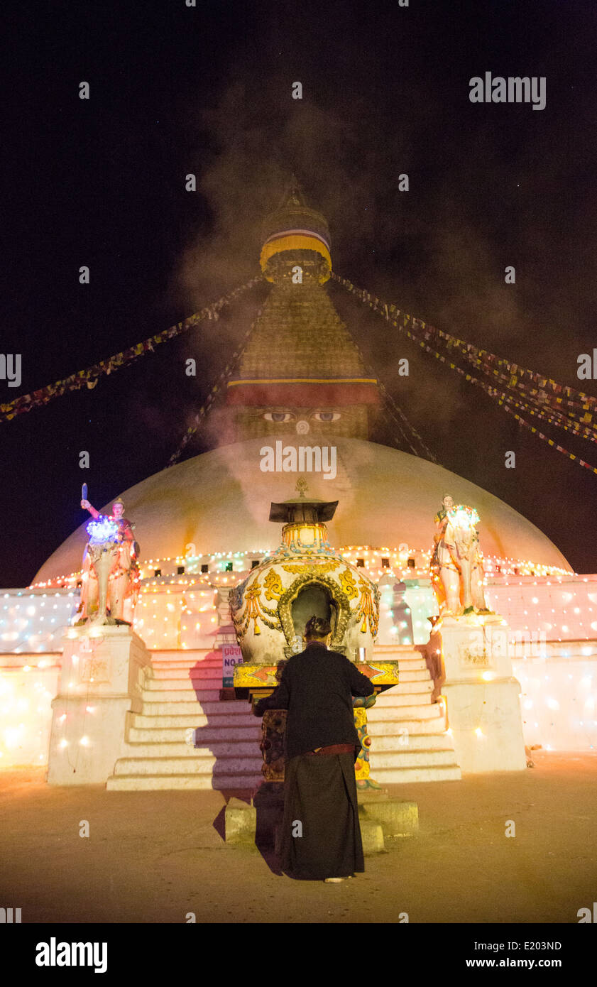Kathmandu Nepal old woman praying at the Boudhanath Stupa in the early ...