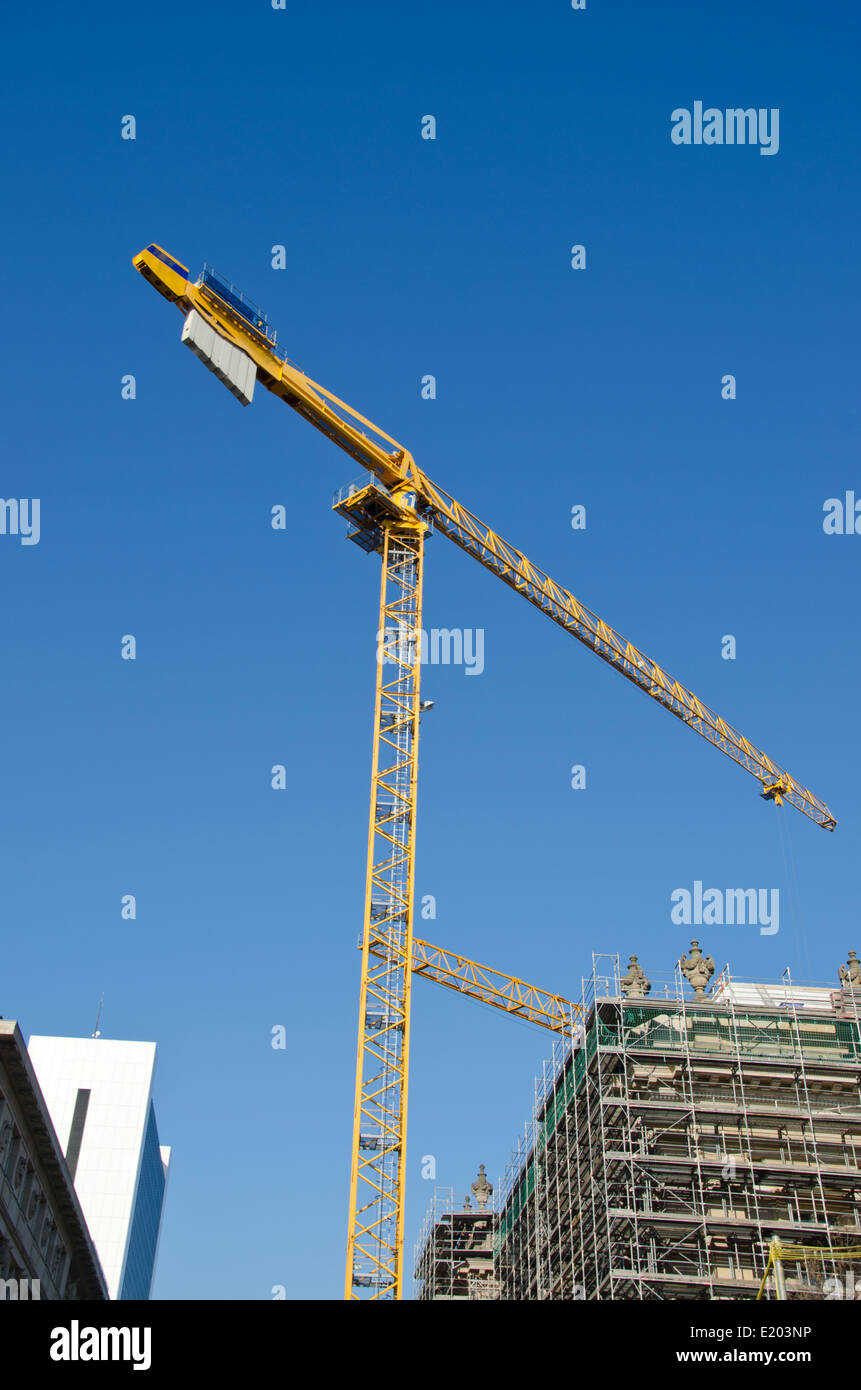 crane skyscraper tower near repair house in city Stock Photo - Alamy