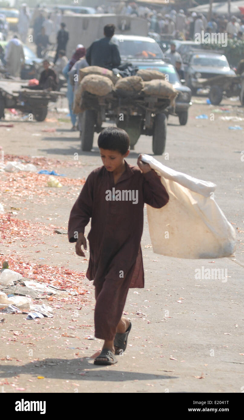 Islamabad, Pakistan. 12th June, 2014. A boy works in a fruit and ...