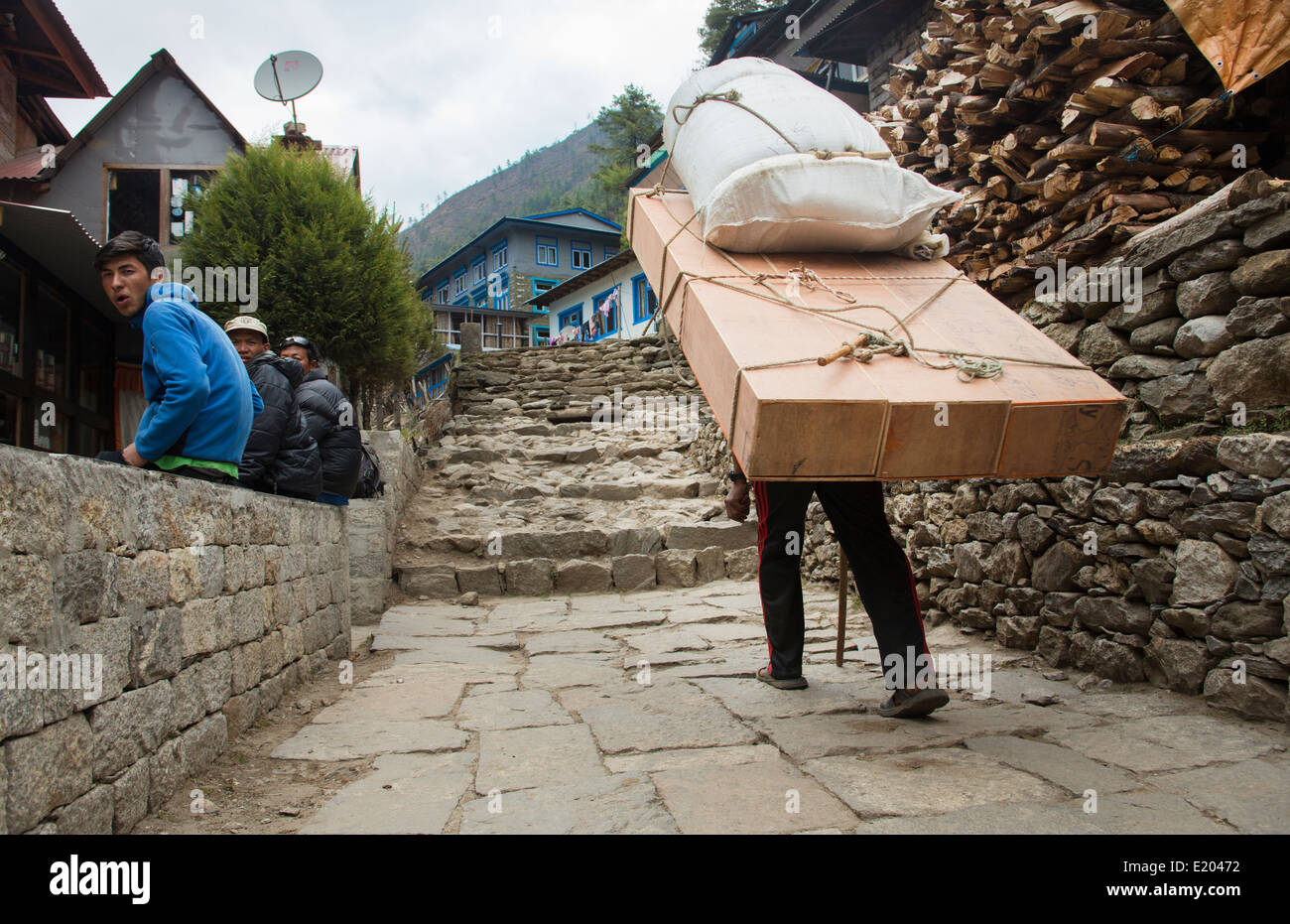 Nepal Himalayas Porter carrying massive load through the streets of ...