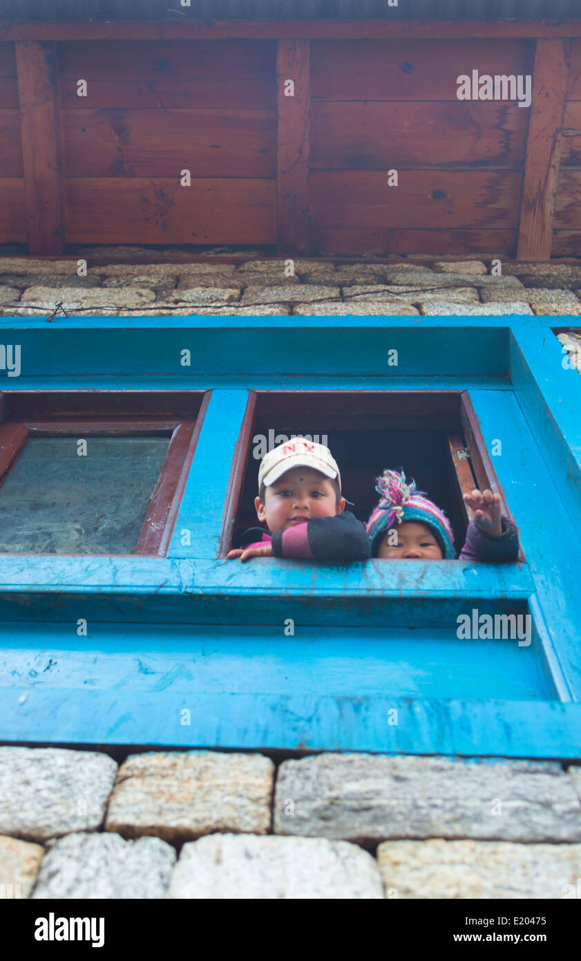 Nepal Himalayas Children peer out window in Phak Ding Solukhumbu remote ...