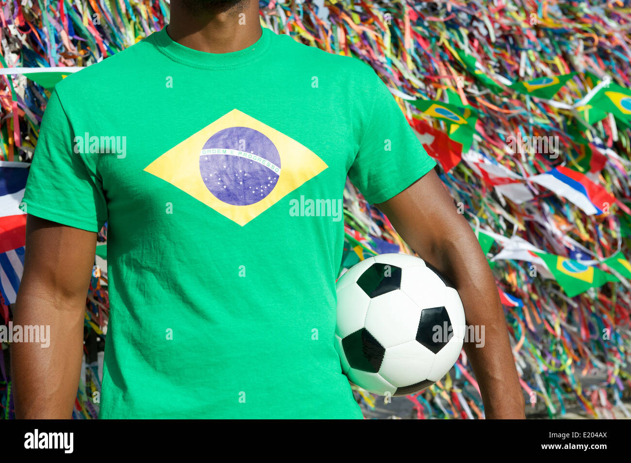Brazilian football player standing with soccer ball in front of ...