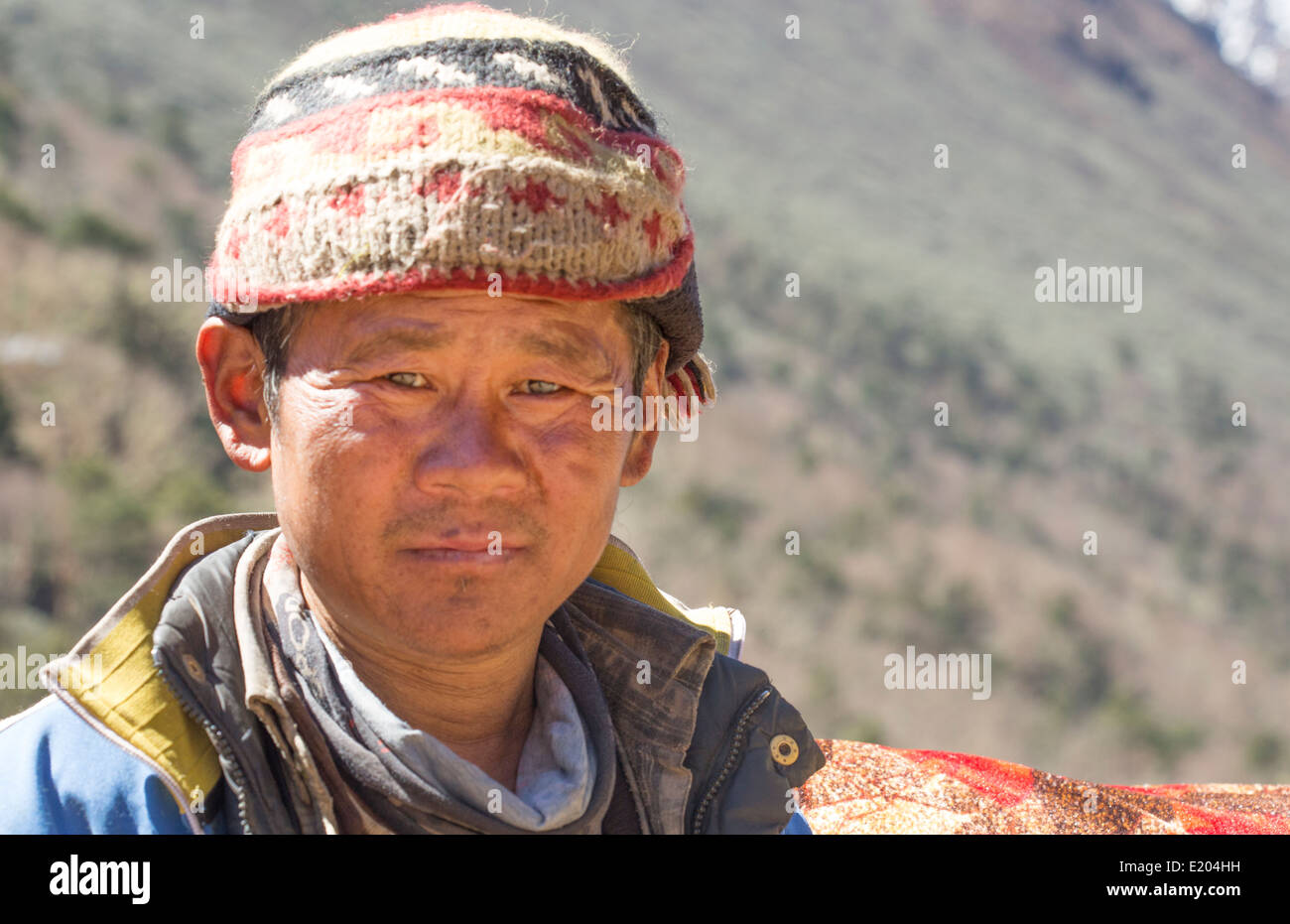 Nepal. Porter poses for camera outside the village of Tengboche ...
