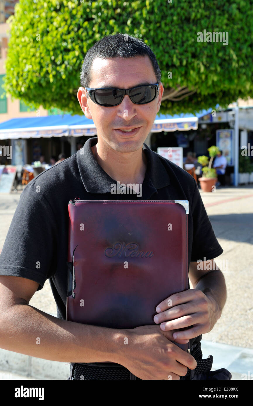 Young man holding restaurant menu Stock Photo - Alamy