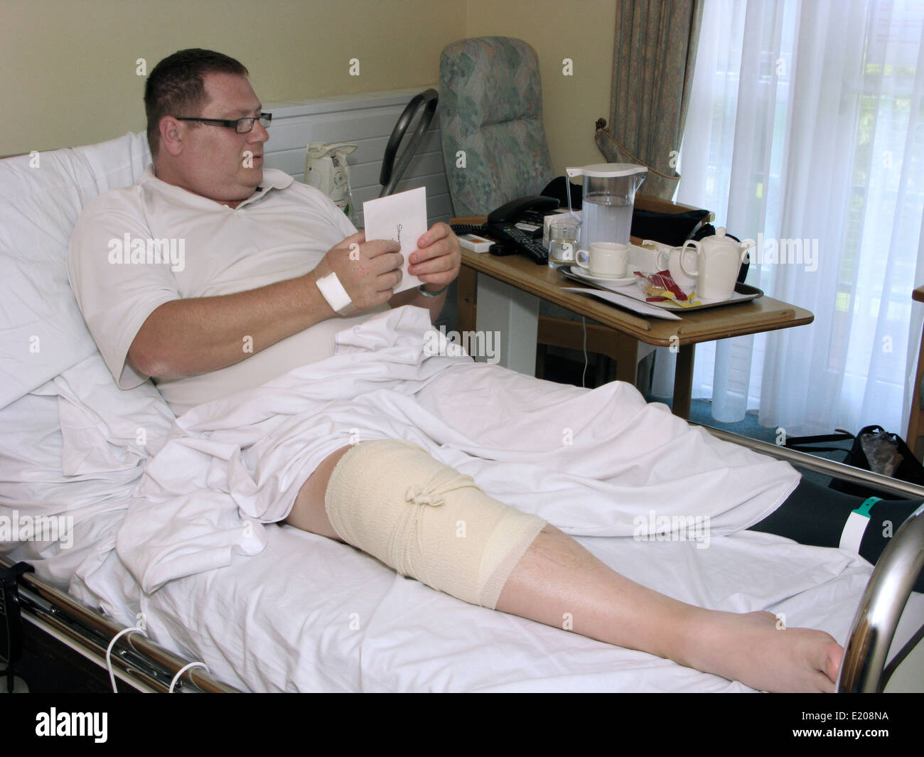 Man in hospital with a bandaged knee & leg after a knee operation Stock ...