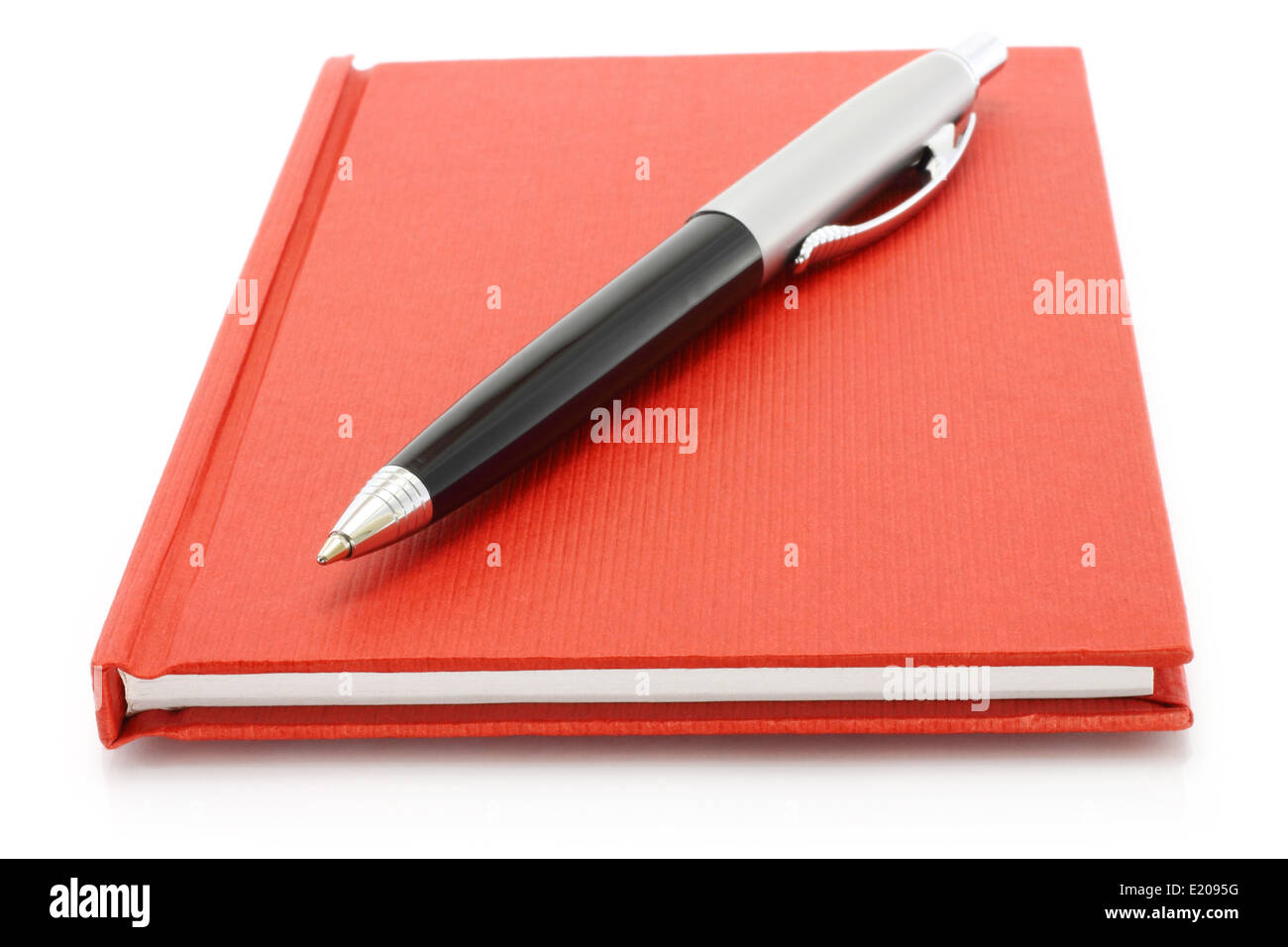 Red notepad with ball pen on a white background Stock Photo - Alamy
