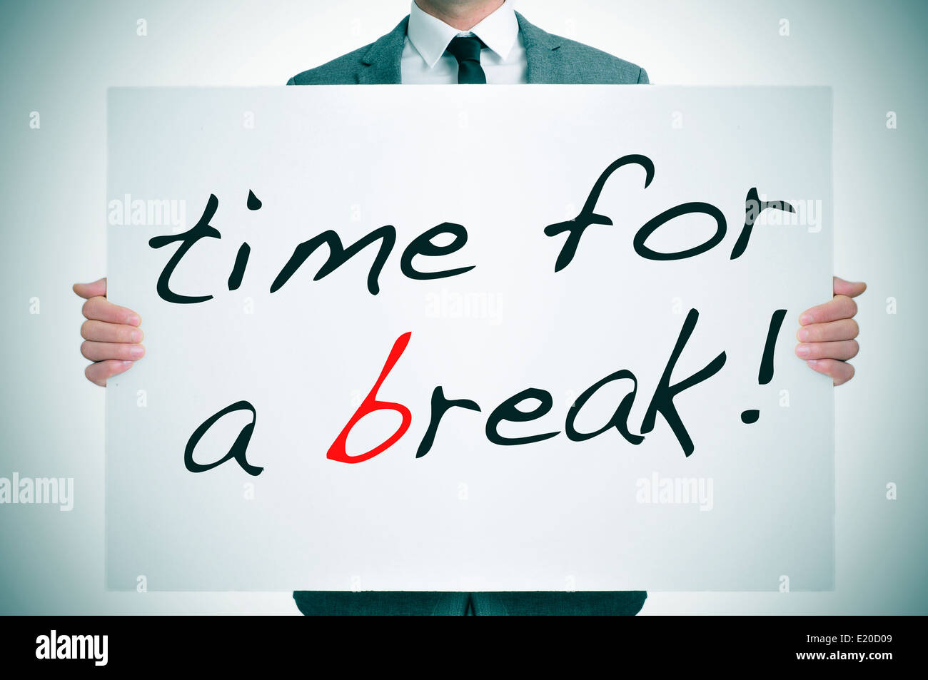 businessman holding a signboard with the text time for a break written ...
