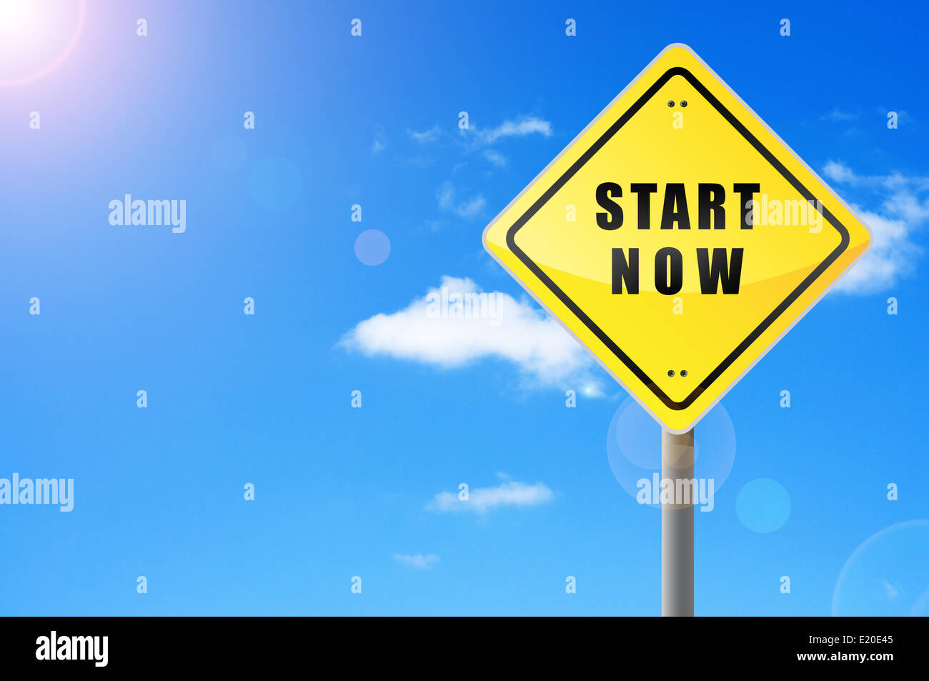 Signpost start now on sky background Stock Photo - Alamy