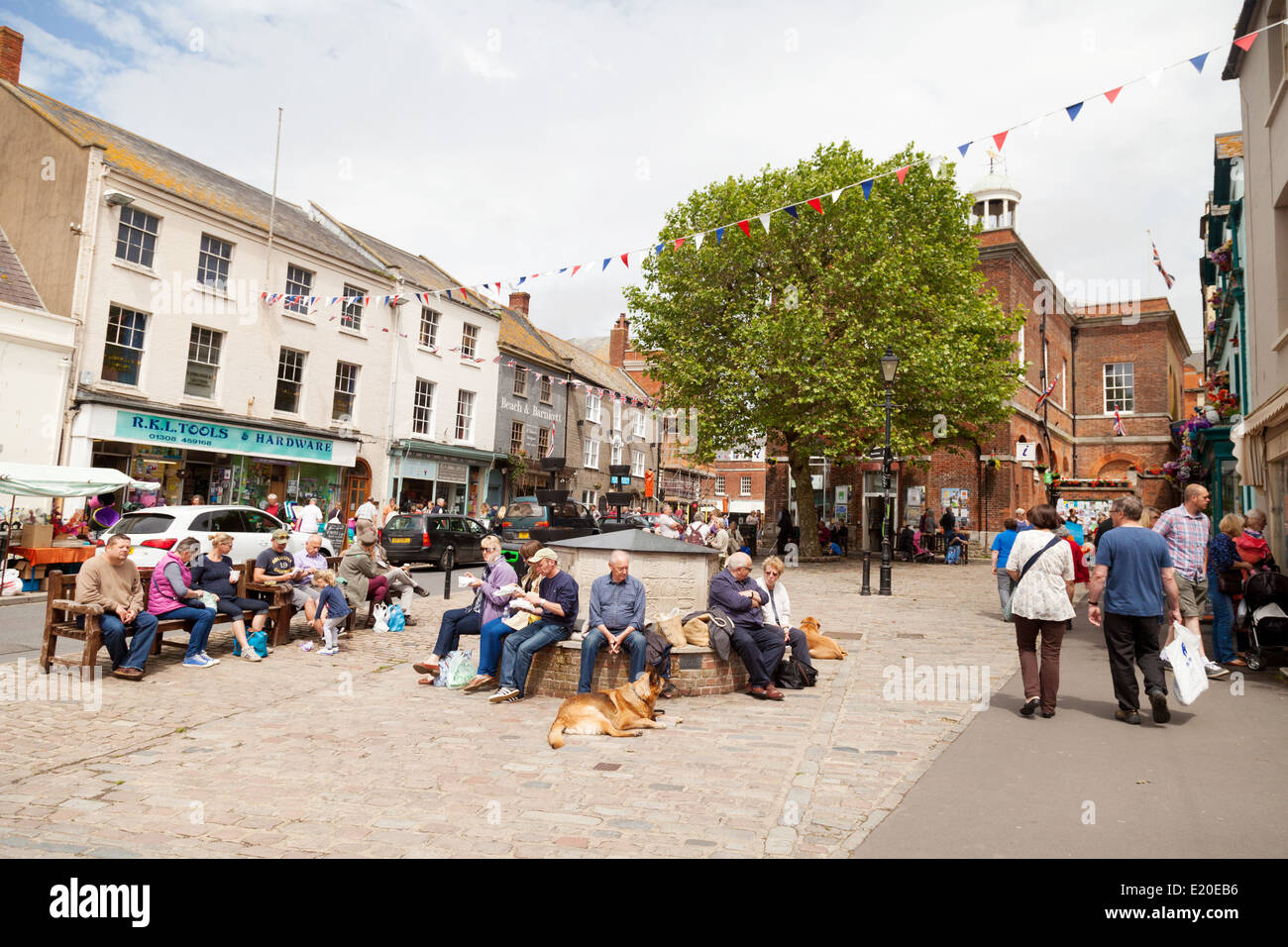 People sitting in the town square on market day, Bridport, Dorset ...