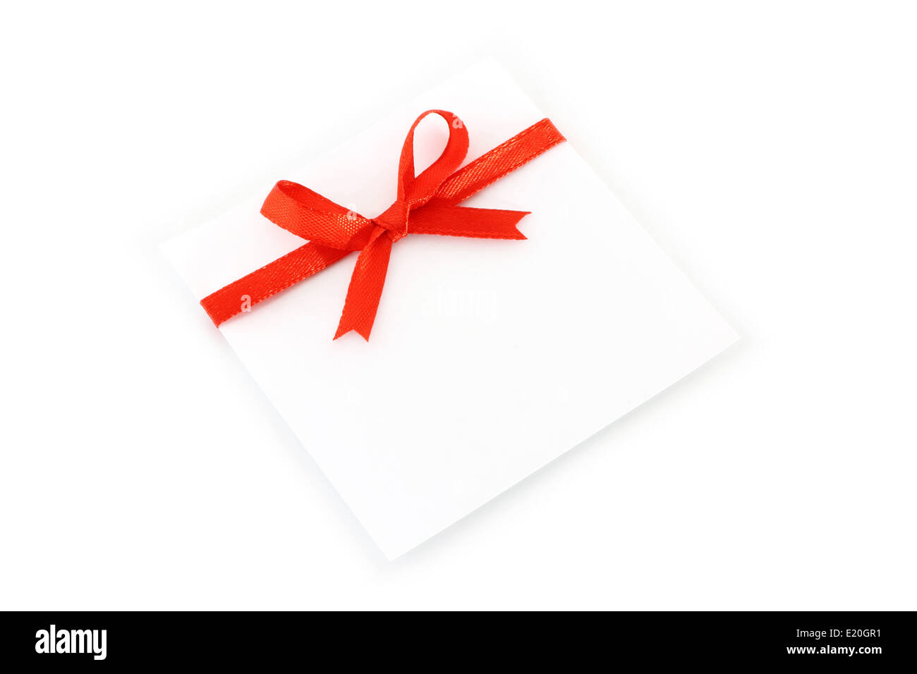 Sheet with red holiday bow on white background Stock Photo - Alamy