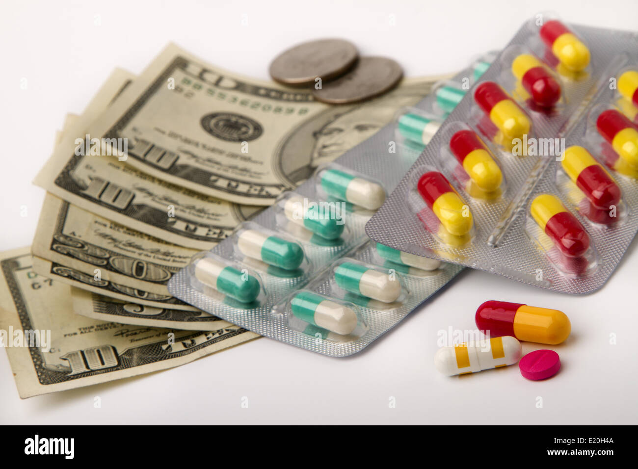 tablets in packs against dollar banknotes Stock Photo - Alamy