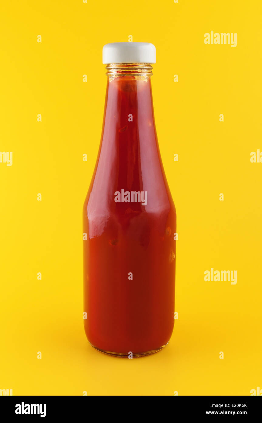 Ketchup in a bottle on yellow background Stock Photo - Alamy