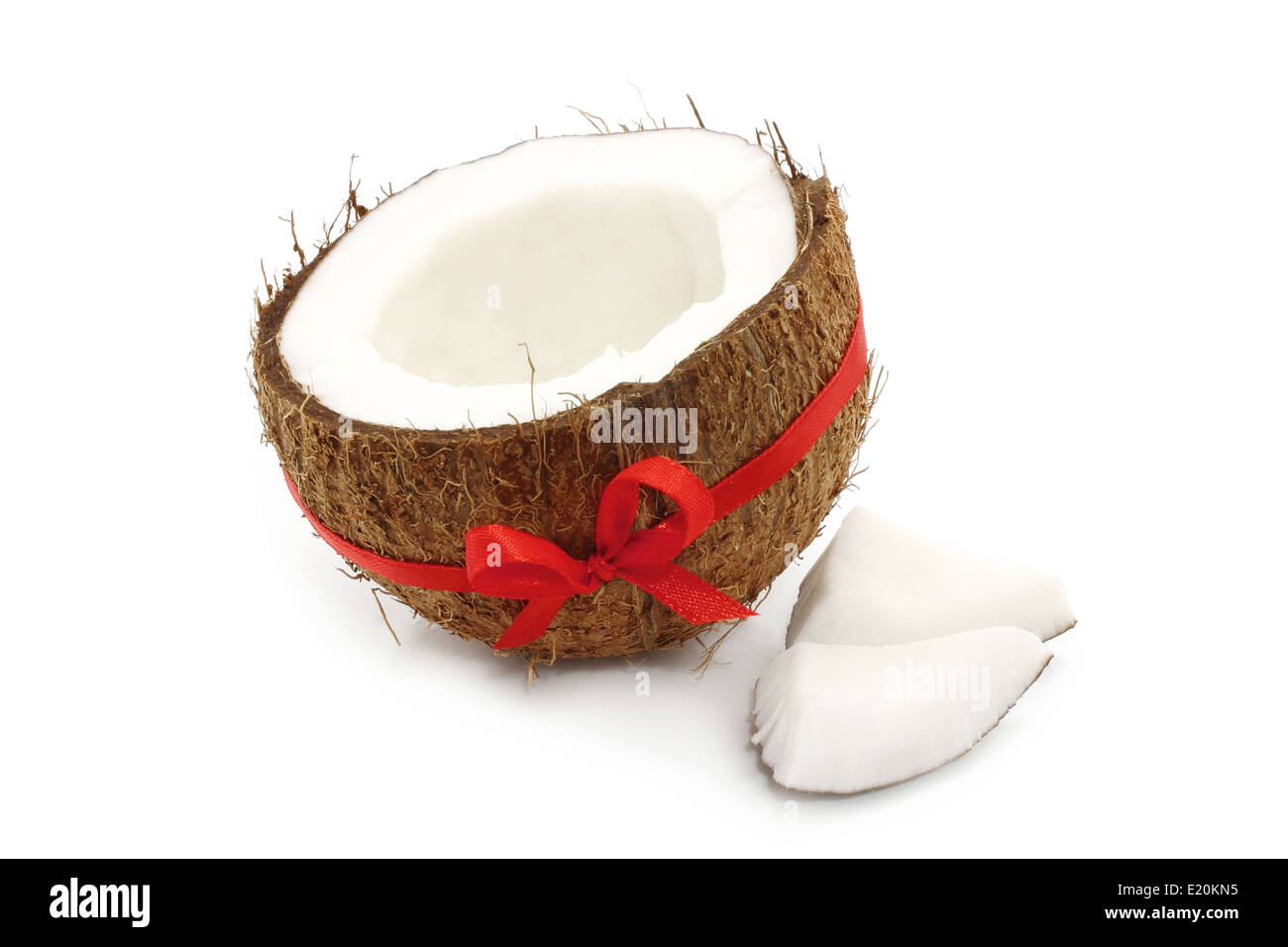 Fresh coconut with red bow on white background Stock Photo - Alamy