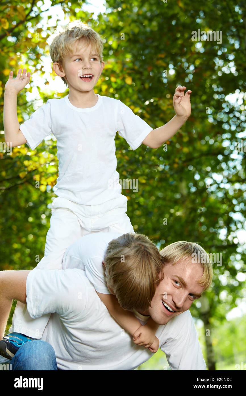 Father with two small sons frolic in park Stock Photo - Alamy
