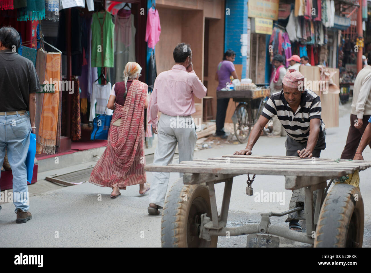 Local man pushing cart through busy street in Kathmandu Nepal Stock ...