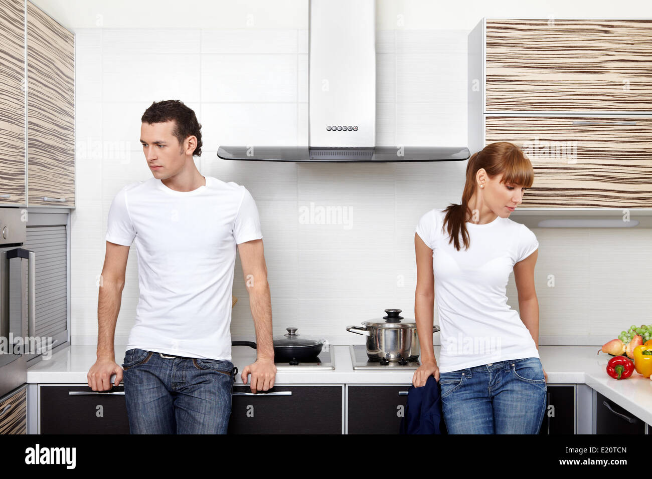 The quarrelled man and the woman on kitchen Stock Photo - Alamy