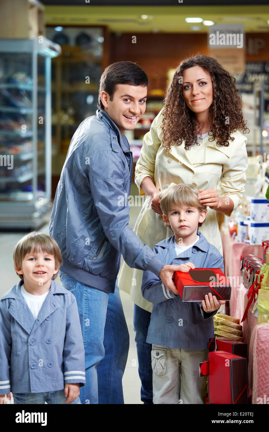 Happy family with children in shop Stock Photo - Alamy