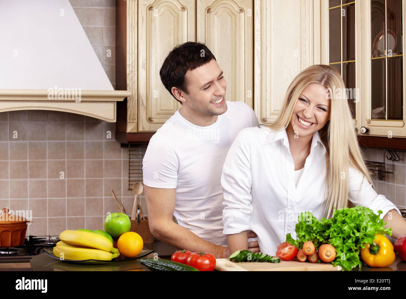 Couple on kitchen Stock Photo - Alamy