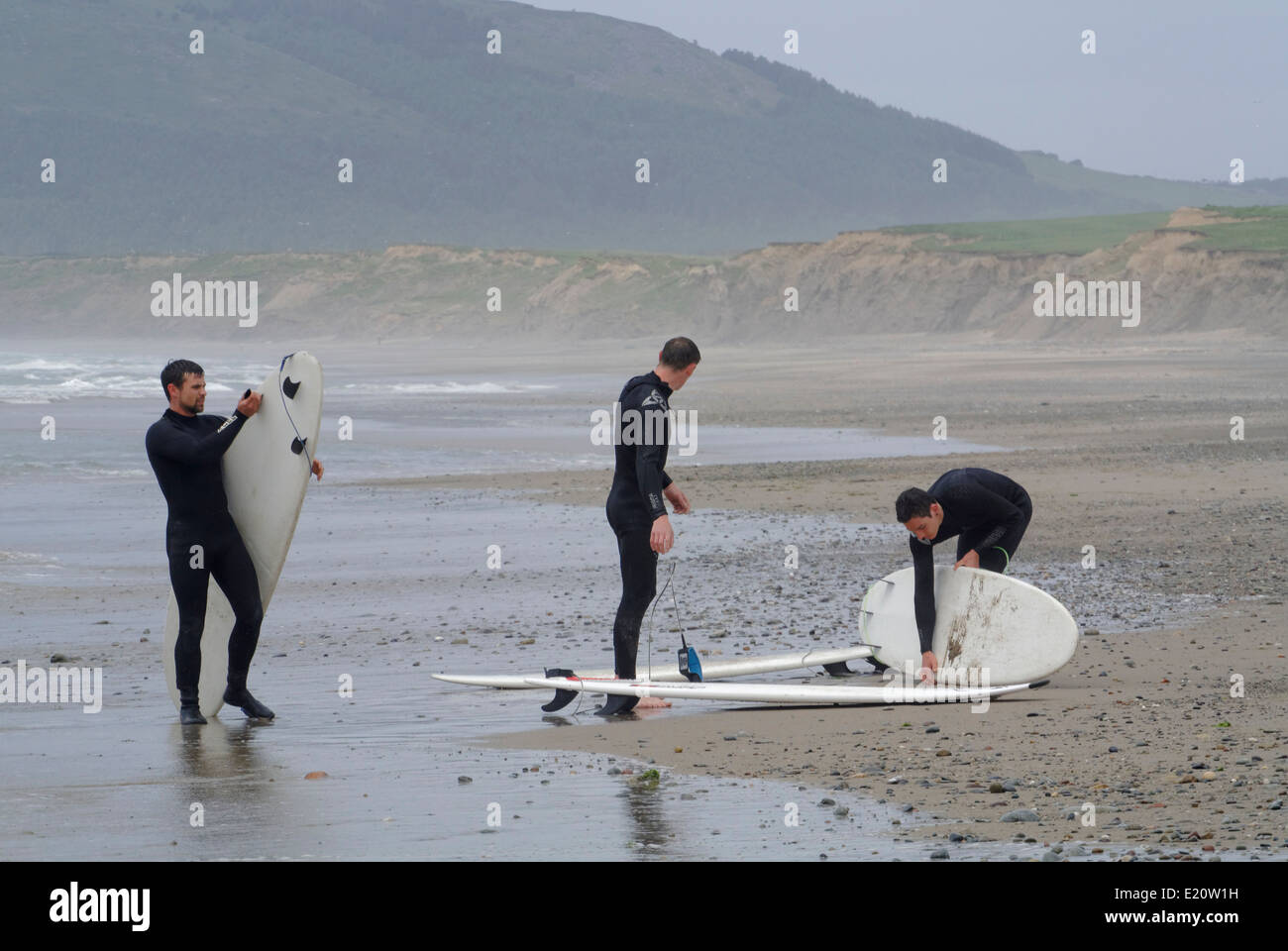 Friends meet after a surfing session at the popular surfing beach of ...