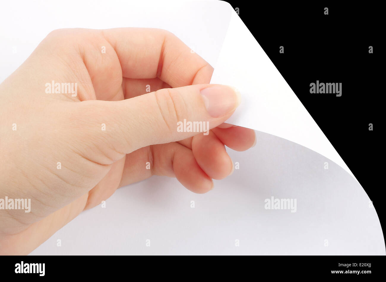 Blank sheet of paper with hand on black background close-up Stock Photo ...
