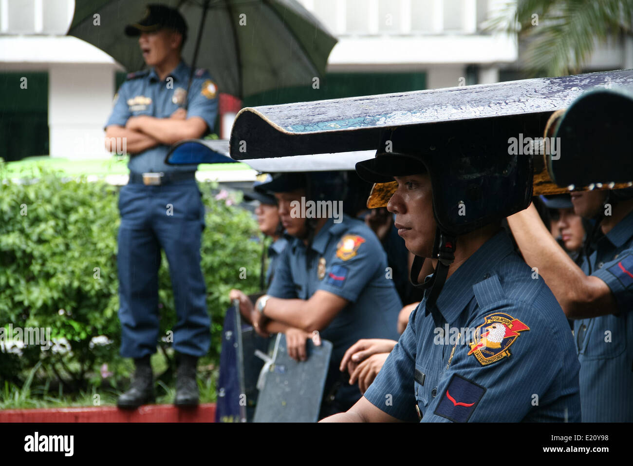 Manila, Philippines. 12th June, 2014. Police officers use their shields ...