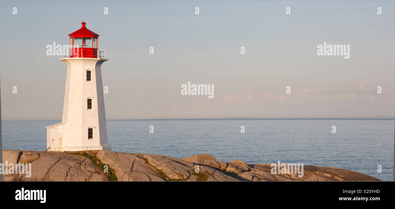 Lighthouse on rocks with water and sky Stock Photo - Alamy