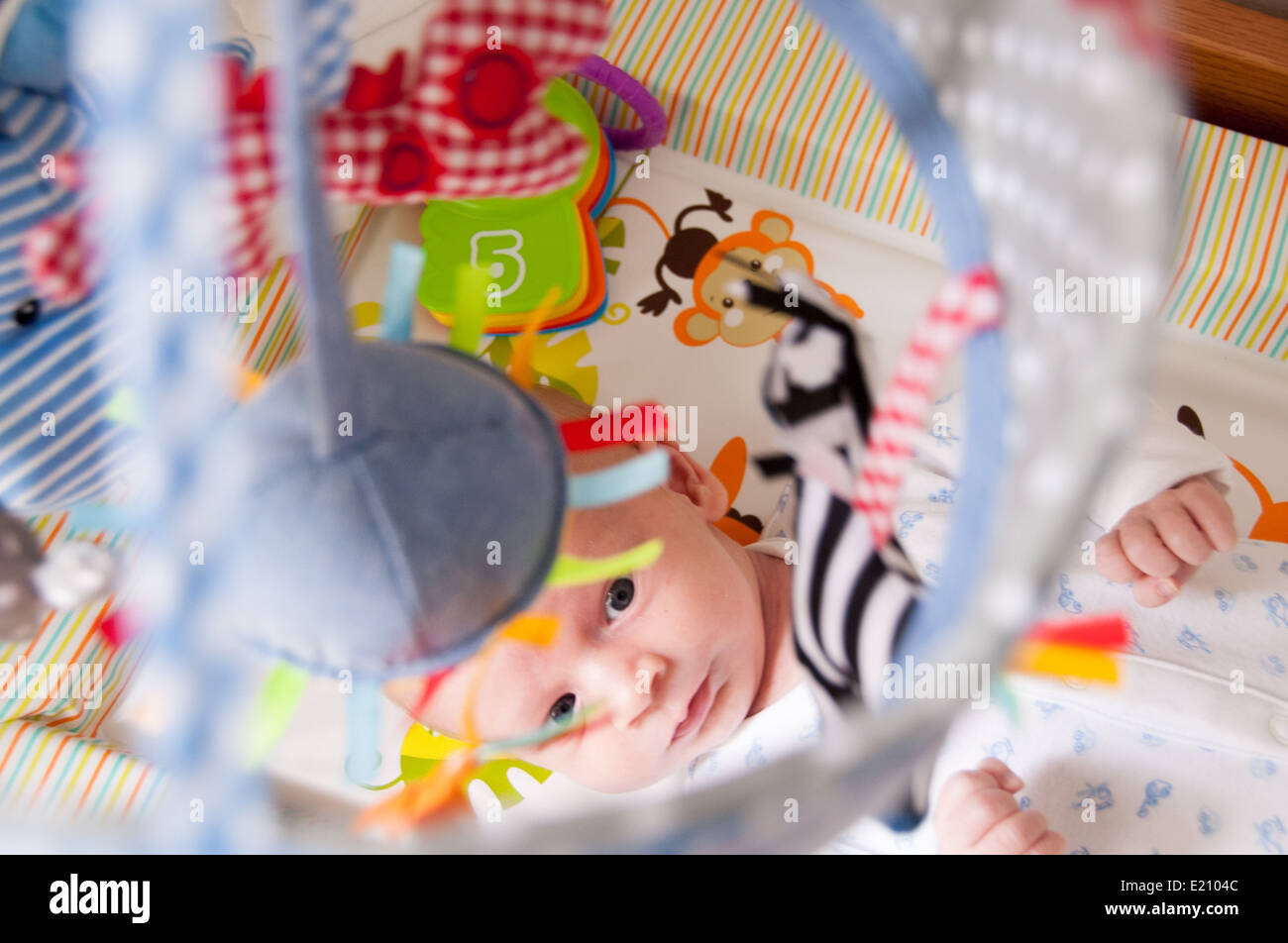 Newborn baby looking up at toy mobile Stock Photo - Alamy