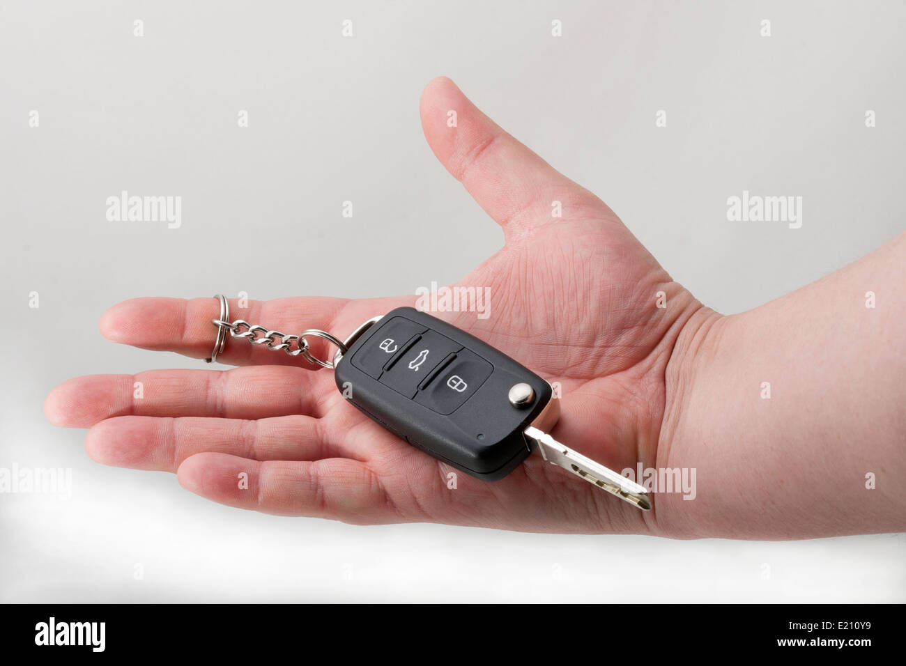 hand holding car keys over white Stock Photo - Alamy