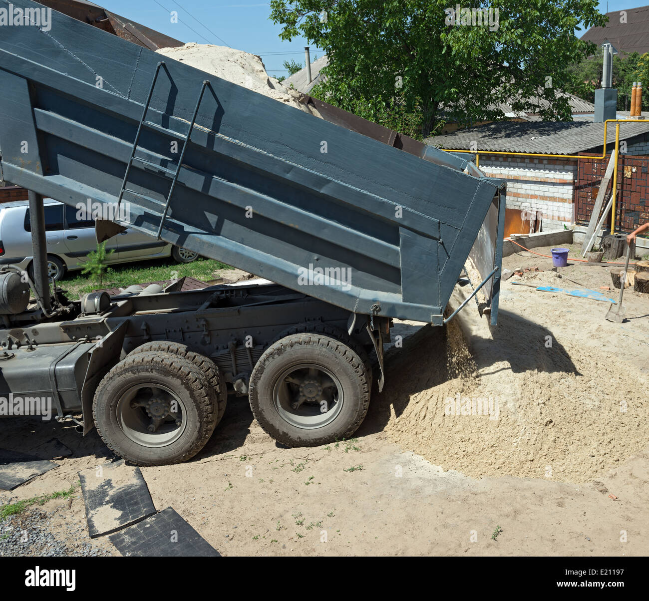 Tip truck is dumping sand in the backyard Stock Photo - Alamy