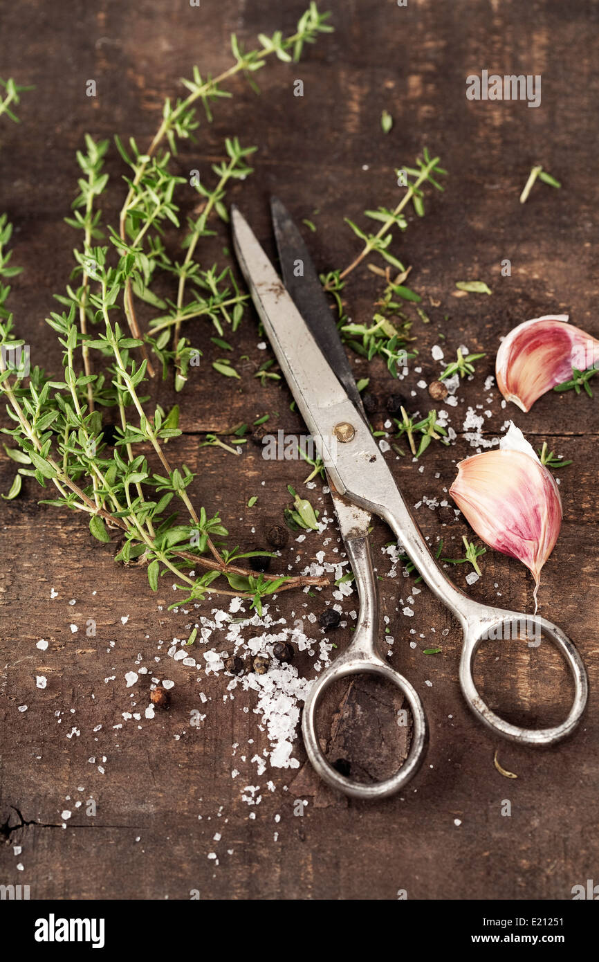Thyme, garlic and scissors on the old kitchen table Stock Photo - Alamy